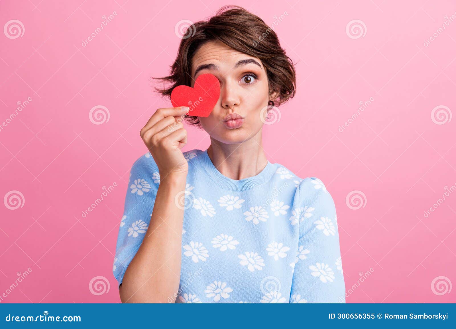 Photo Of Lovely Cute Girl Pouted Lips Kiss Little Paper Heart Cover One Eye Isolated On Pink
