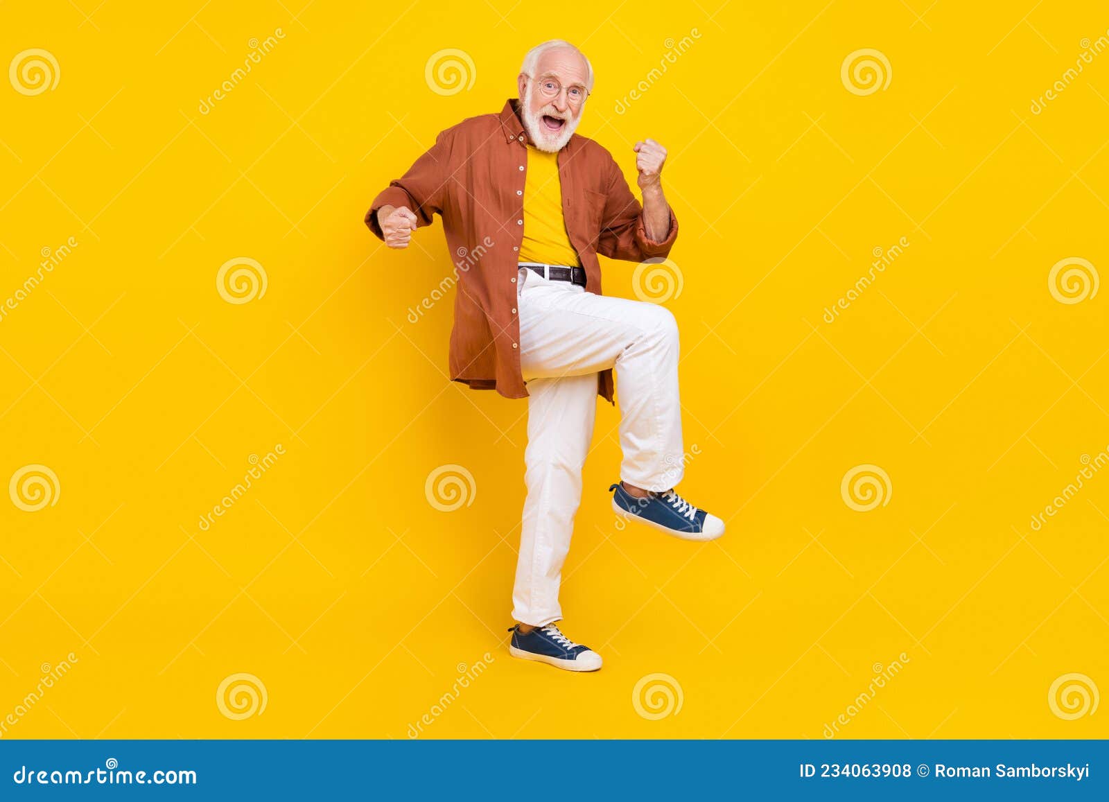Photo Of Lucky Old Man Raise Hands Celebrate Victory Wear Specs Brown Shirt Pants Shoes Isolated