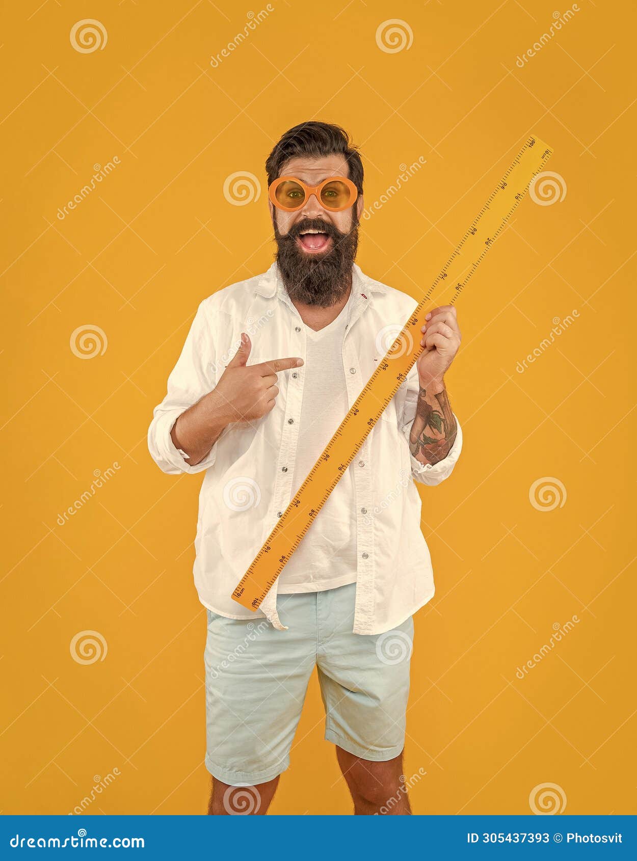 Photo of Man Hold Measuring Ruler, Point Finger Isolated on Yellow in ...