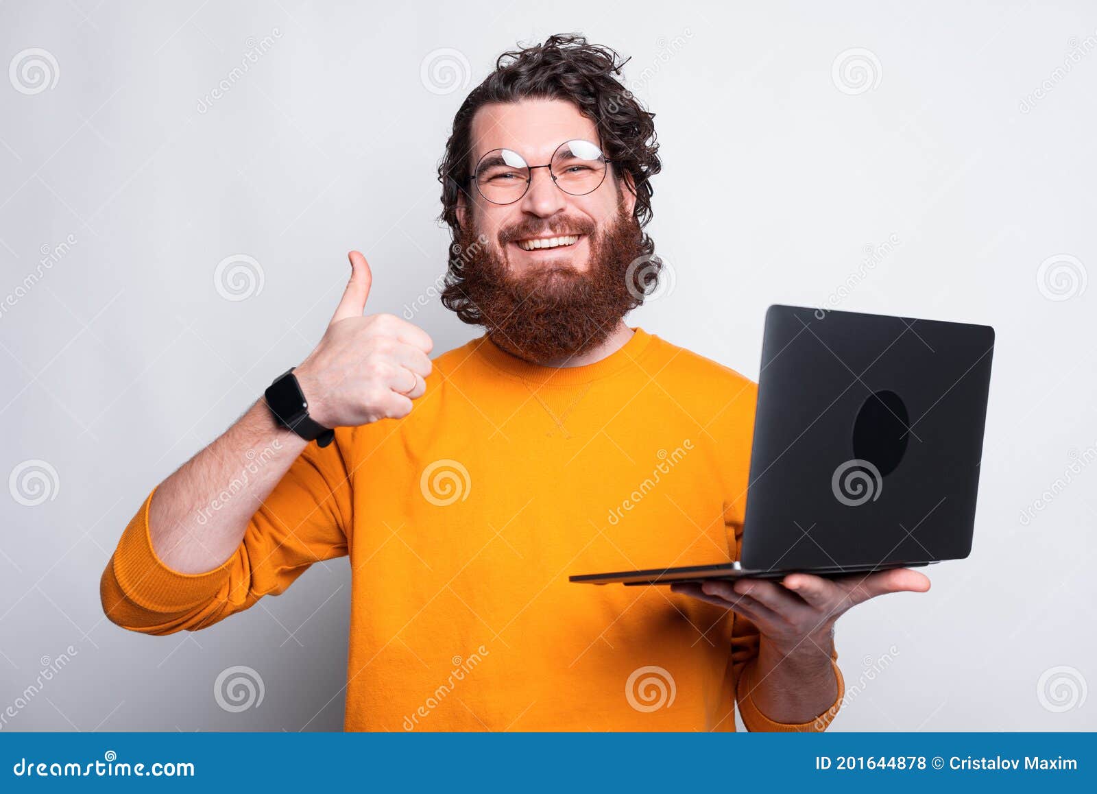 Photo of a Man Holding a Computer is Showing a Thumb Up and Smiling is ...