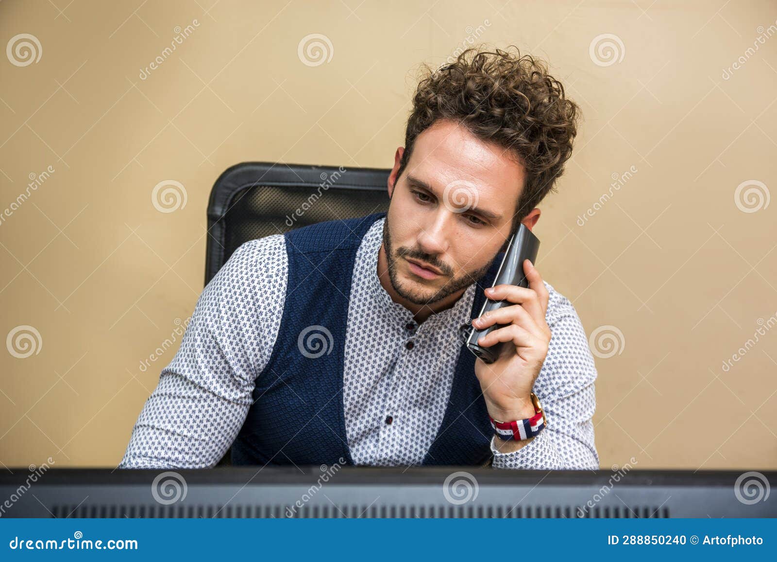 Photo of a Man Multitasking with a Computer and a Cell Phone Stock ...