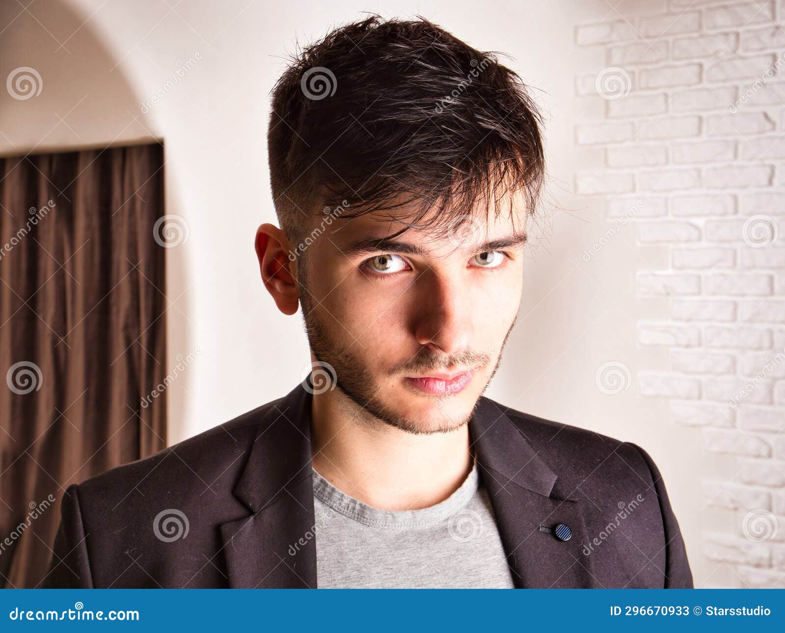 Photo of a Man Standing in Front of a White Brick Wall Stock Image ...