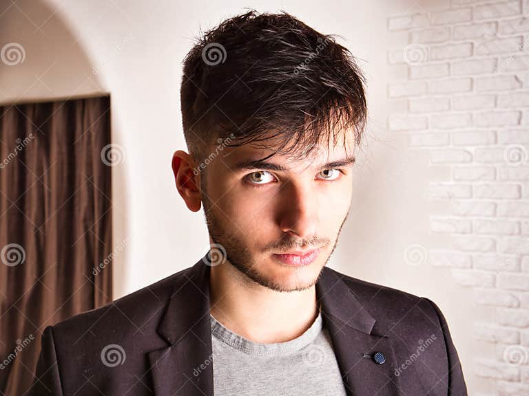 Photo of a Man Standing in Front of a White Brick Wall Stock Image ...