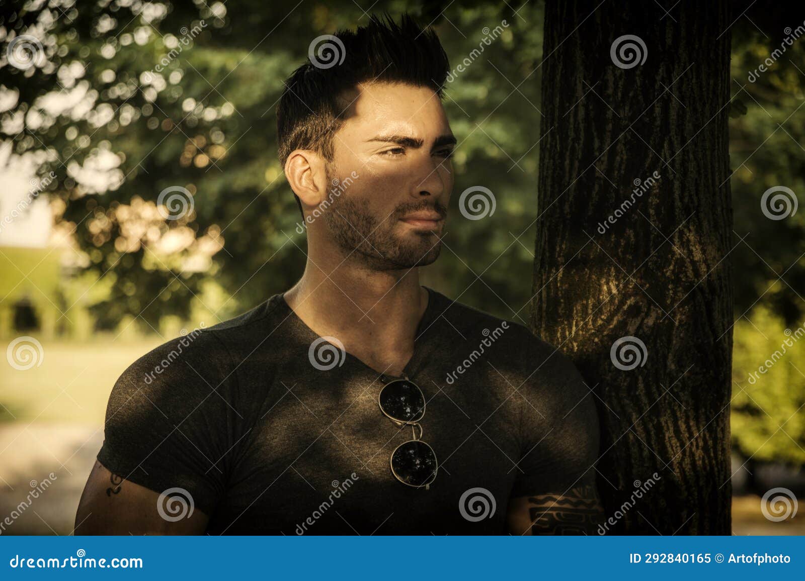 Photo of a Man Standing Next To a Tree in a Park Stock Image - Image of ...