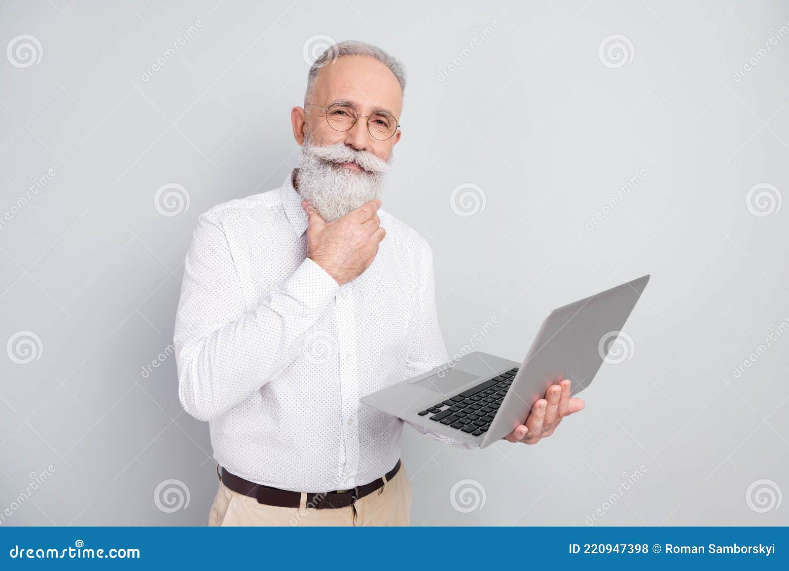 Photo Of Minded Happy Old Man Hold Hand Beard Laptop Good Mood Smile