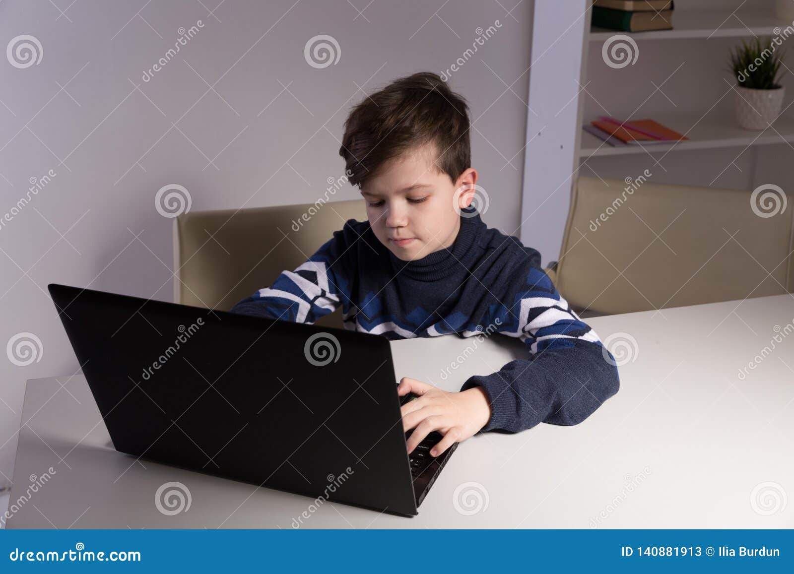 Photo of Nice Boy in Sweater Sitting Infront of the Computer Doing ...