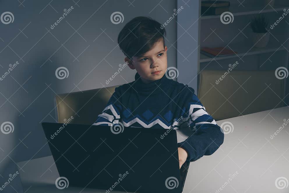 Photo of Nice Boy in Sweater Sitting Infront of the Computer Doing ...