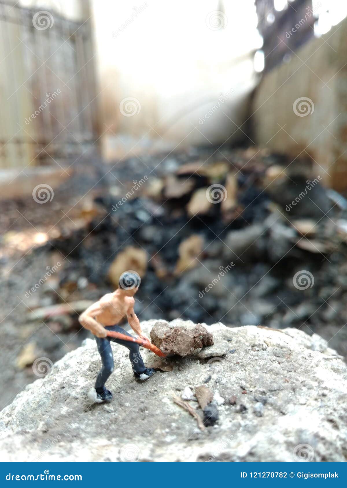 One Small Worker Lifting Stone Using Shovel in Front of Burned Trash ...