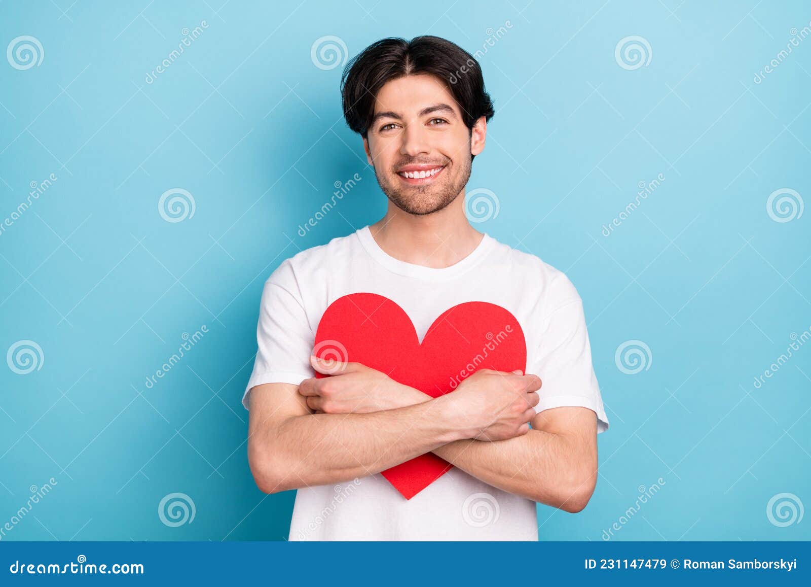 Photo Of Optimistic Millennial Brunet Guy Hug Heart Wear White T Shirt