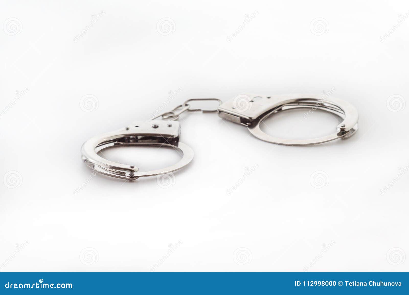Photo of a Pair of Handcuffs Isolated on a White Background Stock Photo ...