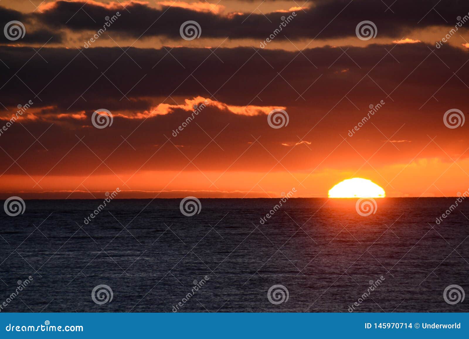 The Sun Setting in the Sea stock photo. Image of water - 145970714