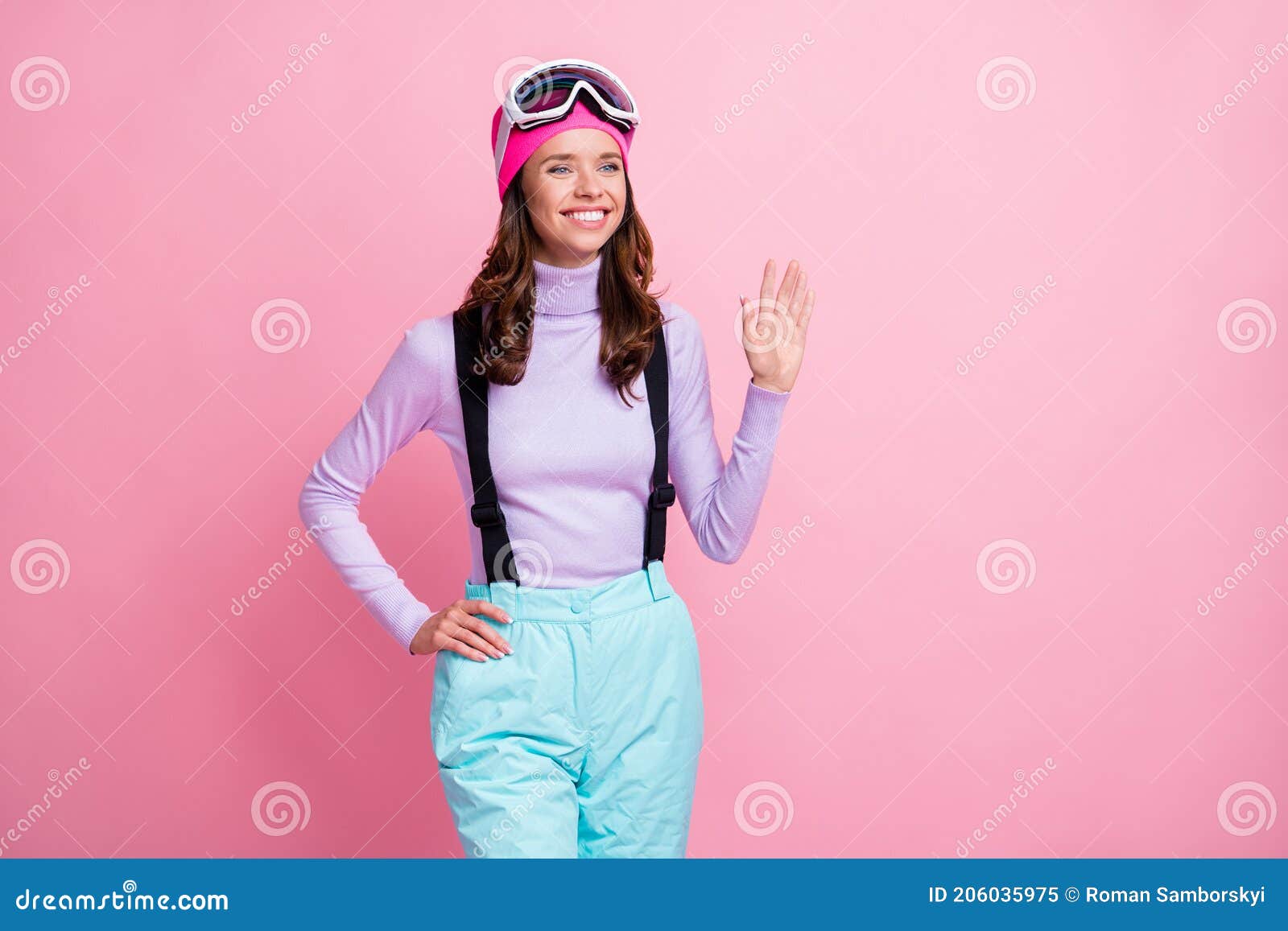 Photo Portrait Of Cheerful Girl Waving Hand Isolated On Pastel Pink