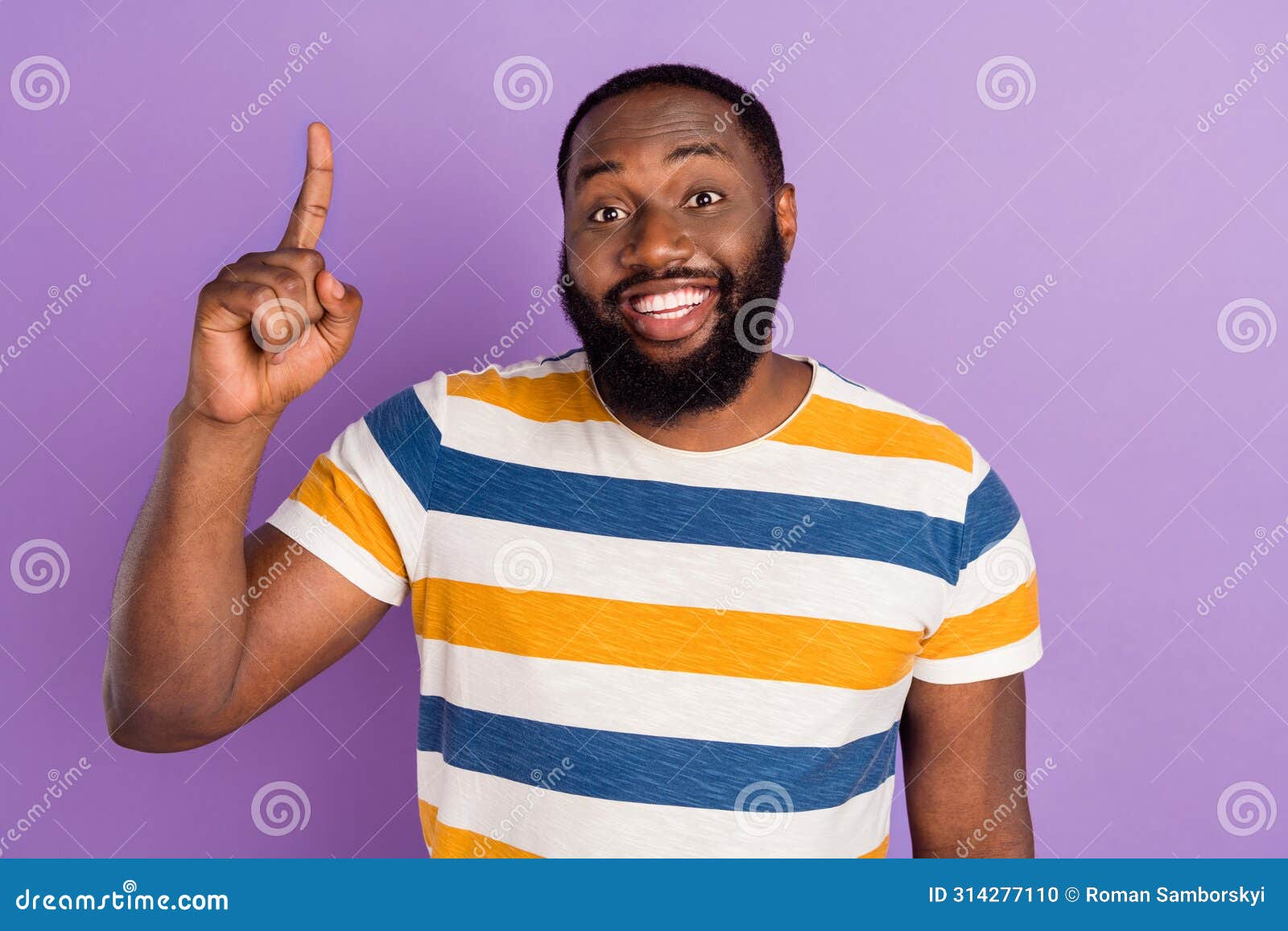 Photo Of Positive Excited Man Wear Striped T Shirt Pointing Finger