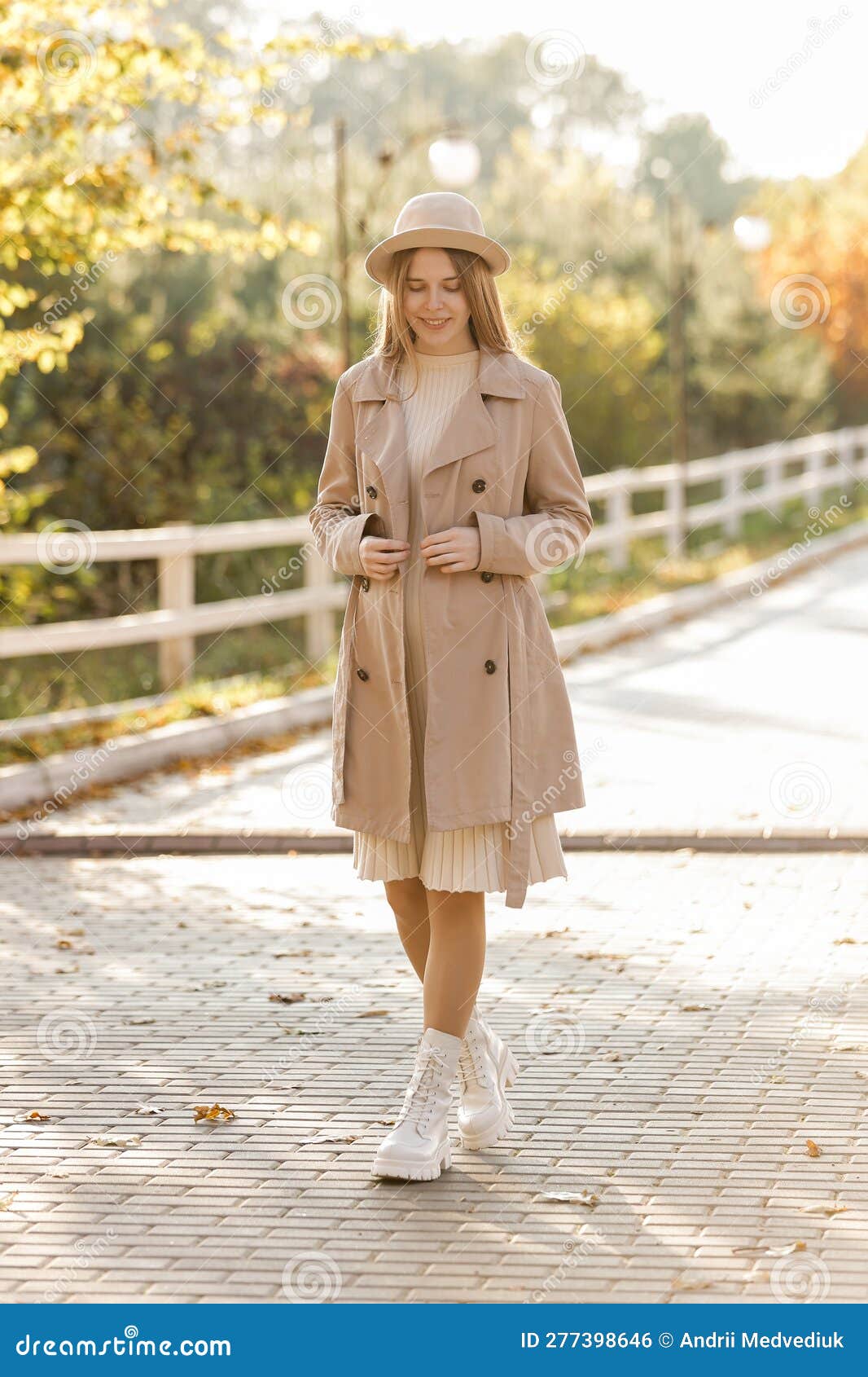 Photo Of Pregnant Woman Holds Hands On Belly In The Autumn Park Young
