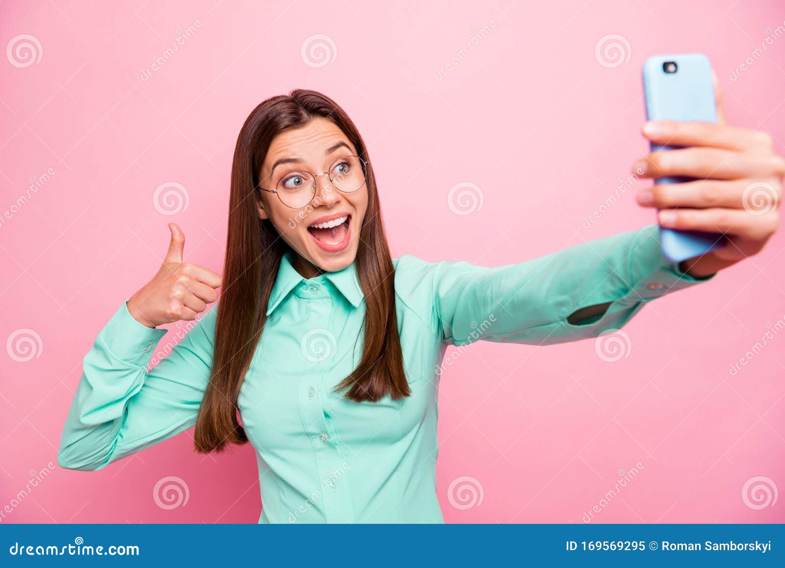 Photo Of Pretty Lady Holding Telephone Making Selfies Raising Thumb