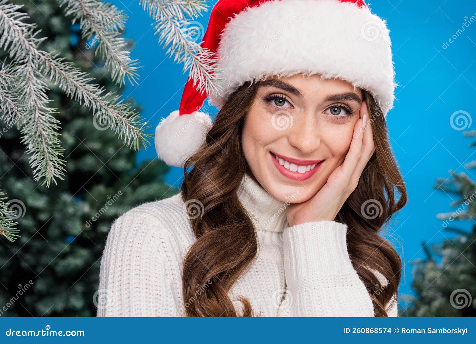 Photo Of Pretty Sweet Lady Wear Santa Claus Helper Hat Arm Cheek