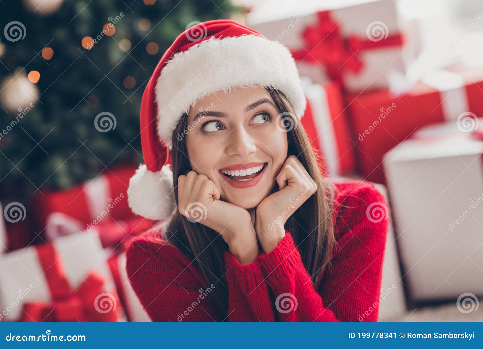 Photo Of Pretty Woman Sit Floor Presents Fists Cheekbones Wear Santa