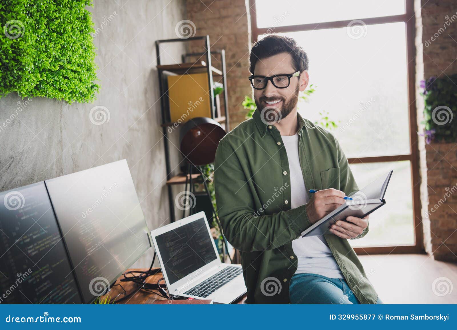 Photo of Professional it Specialist Young Man Write Notepad Computer ...
