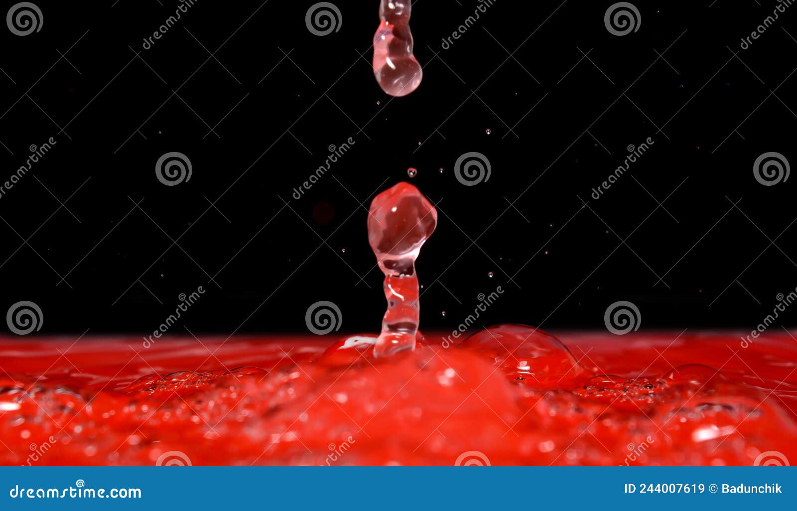 Photo of Red Water Drops Falling on Water and Splash on Black ...