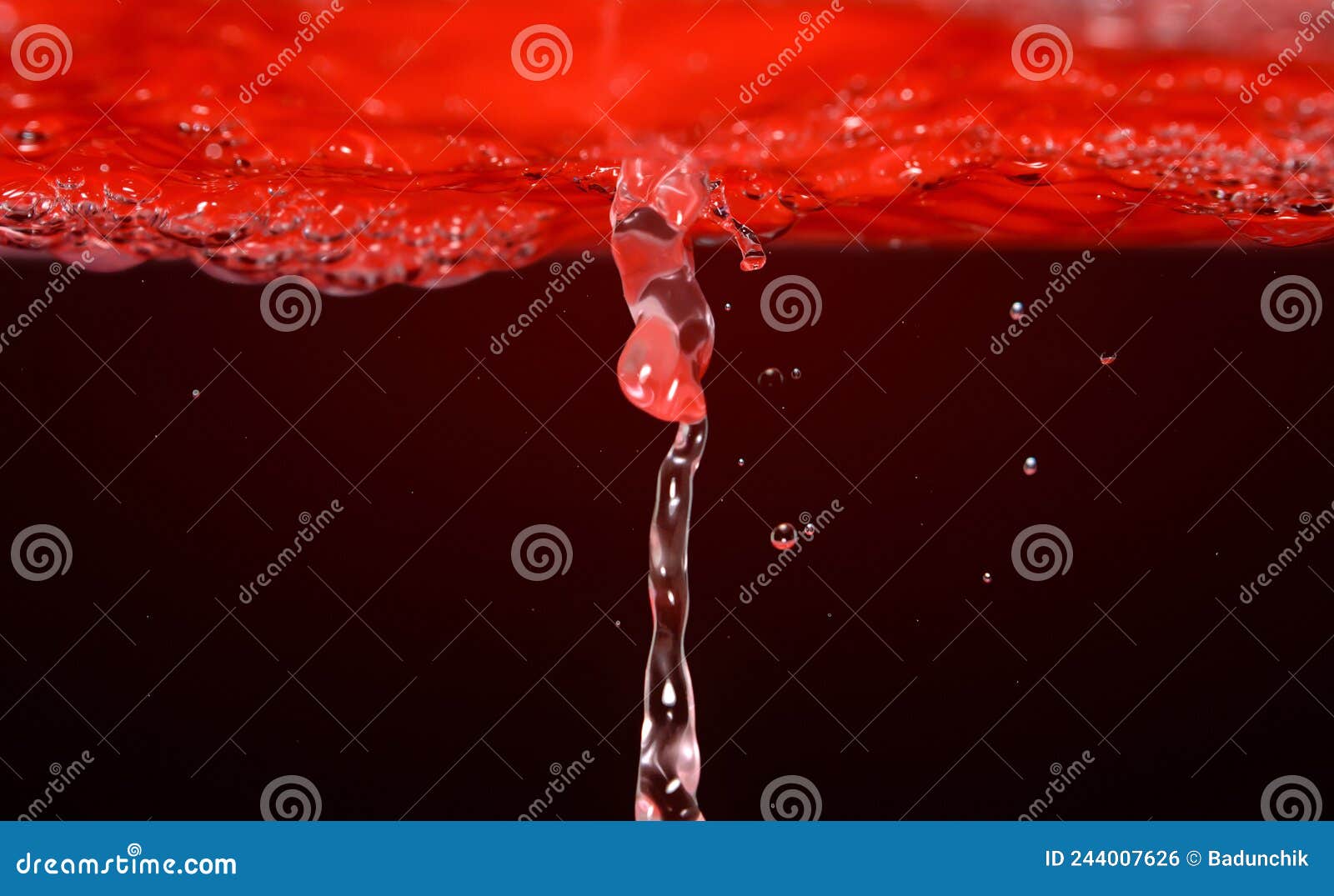 Photo of Red Water Drops Falling on Water and Splash on Black ...