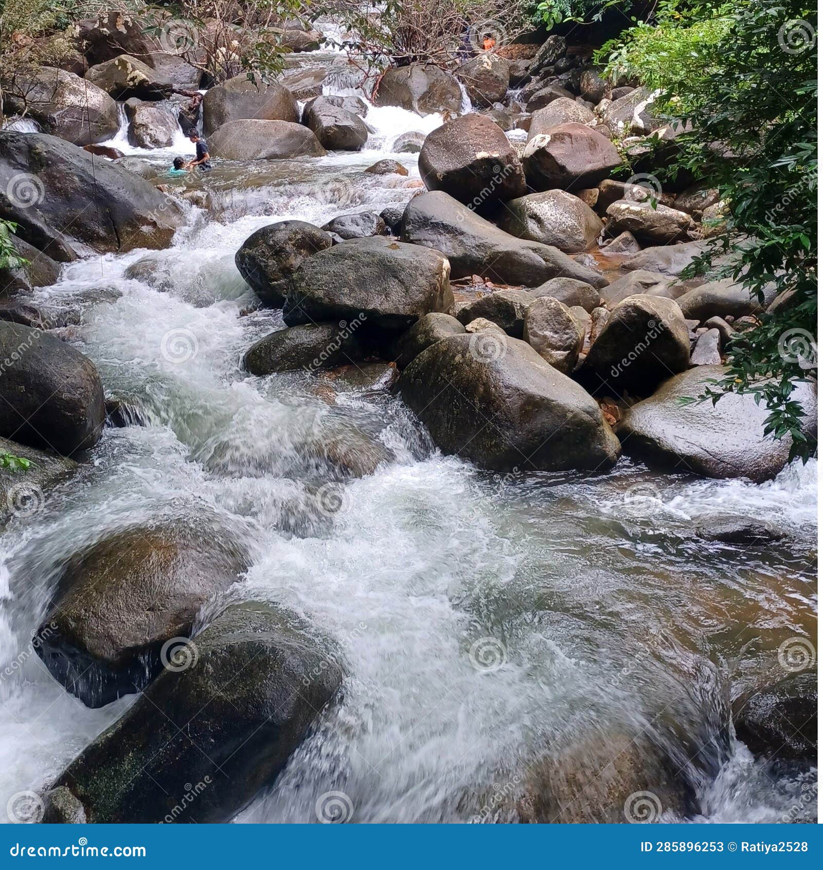 Photo of a River with Water Flowing through the Rocks. Stock Image ...