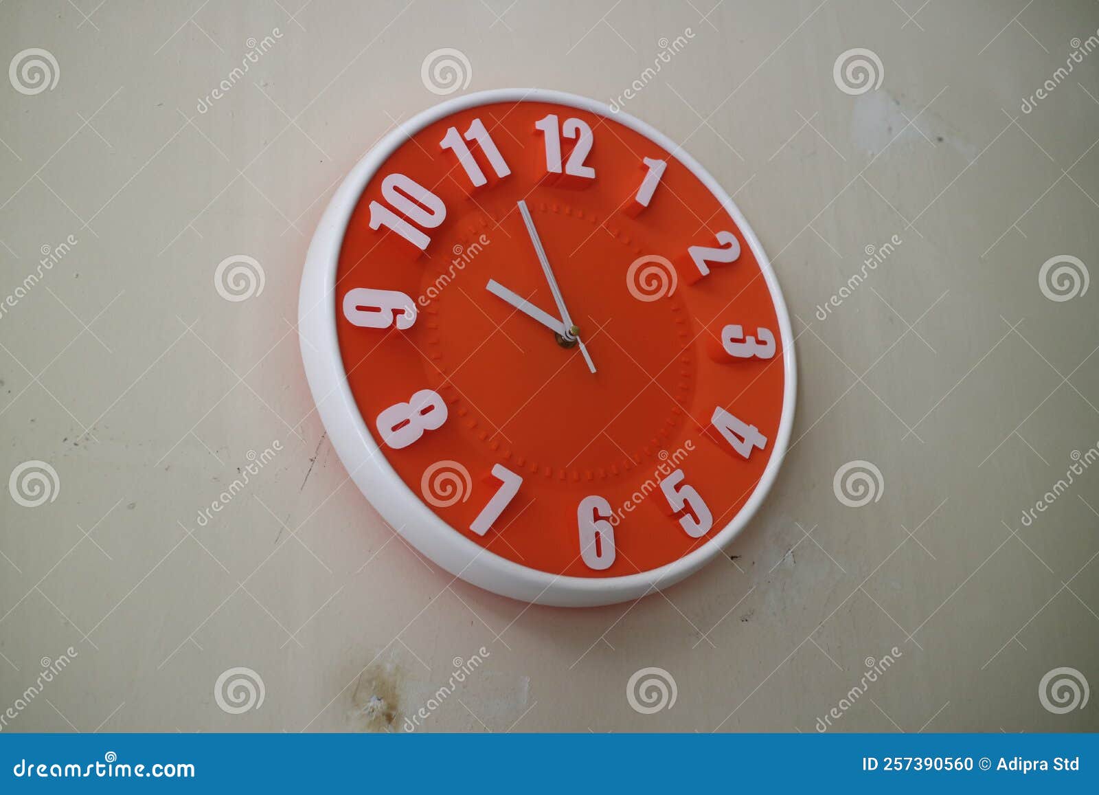 Round Orange Wall Clock with Hands Indicating 10 am Stock Photo - Image ...