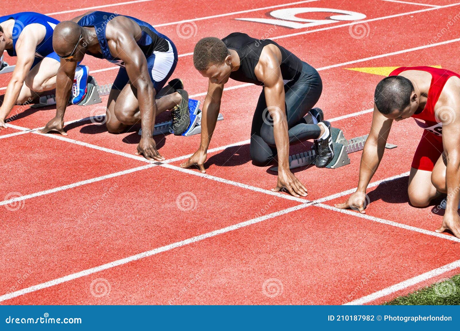 Photo of Runners Waiting in Starting Blocks Stock Photo - Image of ...
