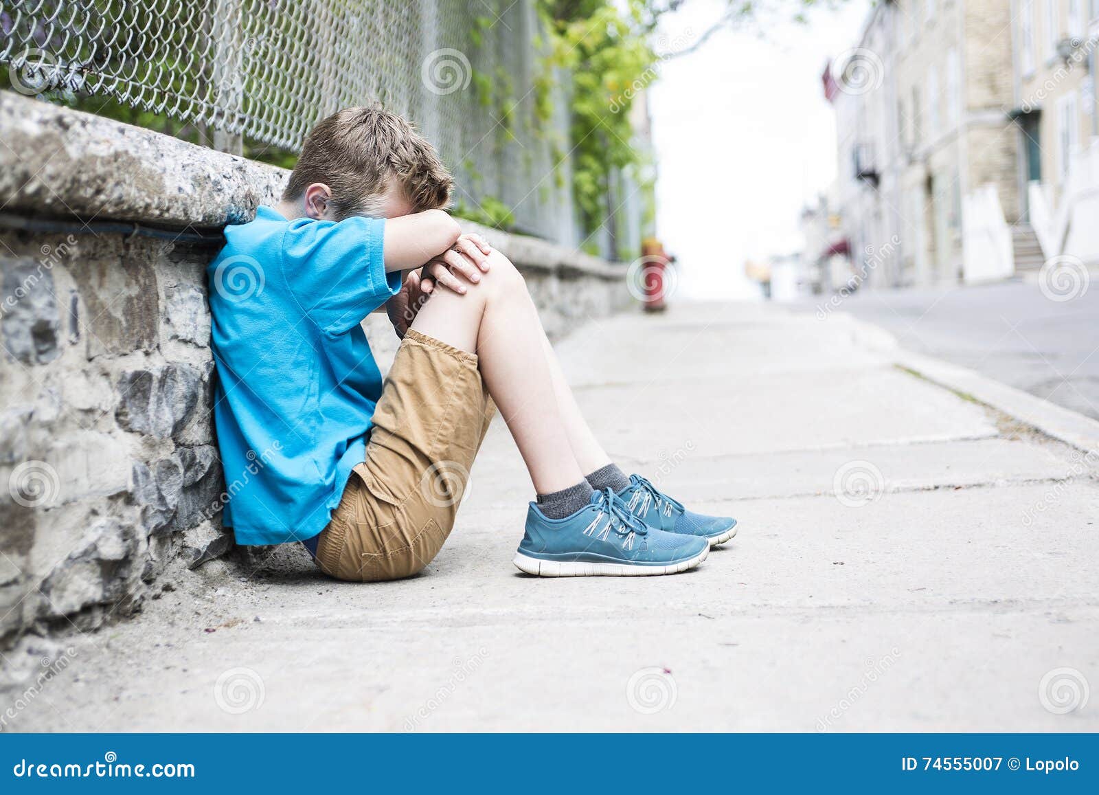 Photo of Sad and Stressed Kid Sit by the Wall Outdoor Stock Image ...