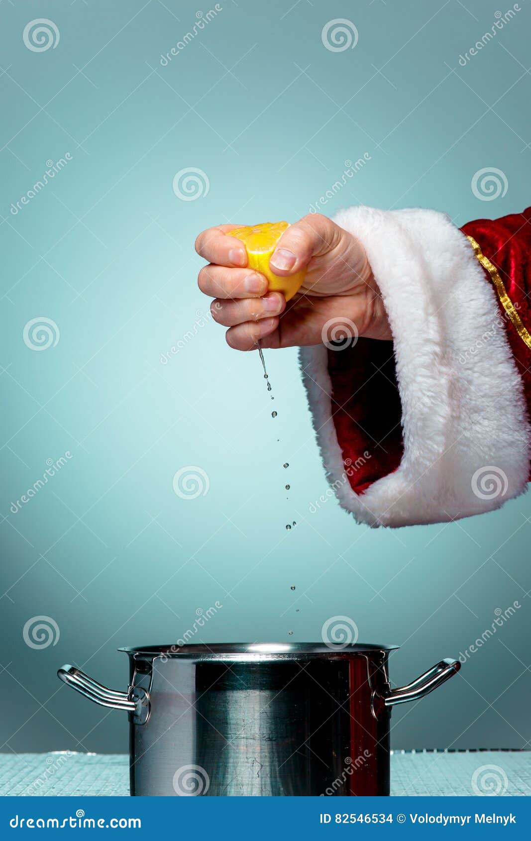 Photo of Santa Claus Hand Squeezing Lemon Stock Photo - Image of ...