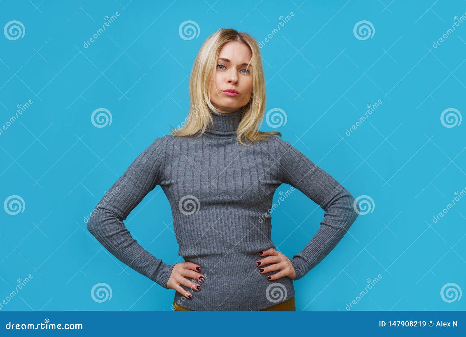 Photo of Serious Blonde in Gray Sweater Looking at Camera Stock Image ...