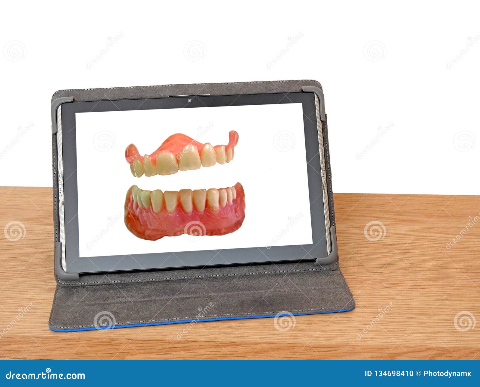 Laughing False Teeth Dentures on Tablet Computer Screen Stock Photo ...