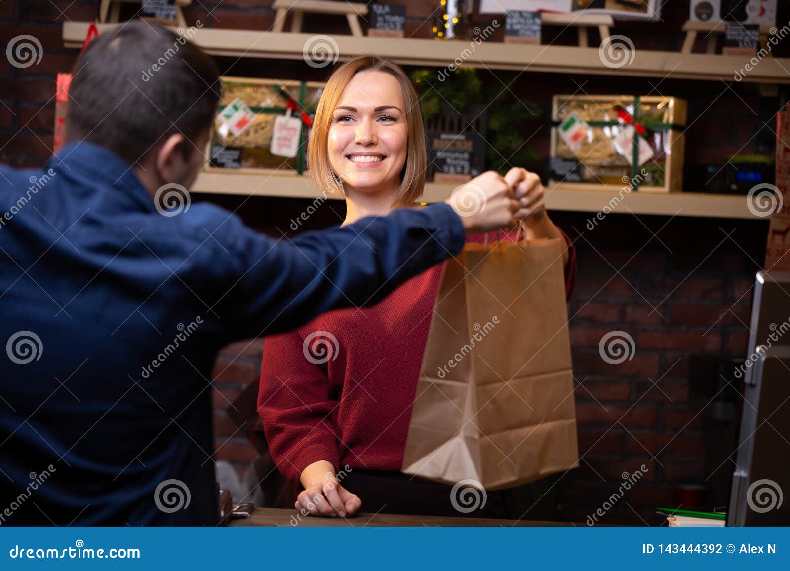 Photo of Smiling Seller Blonde Giving Paper Bag To Man Stock Photo ... Photo of Smiling Seller Blonde Giving Paper Bag To Man Stock Photo ...