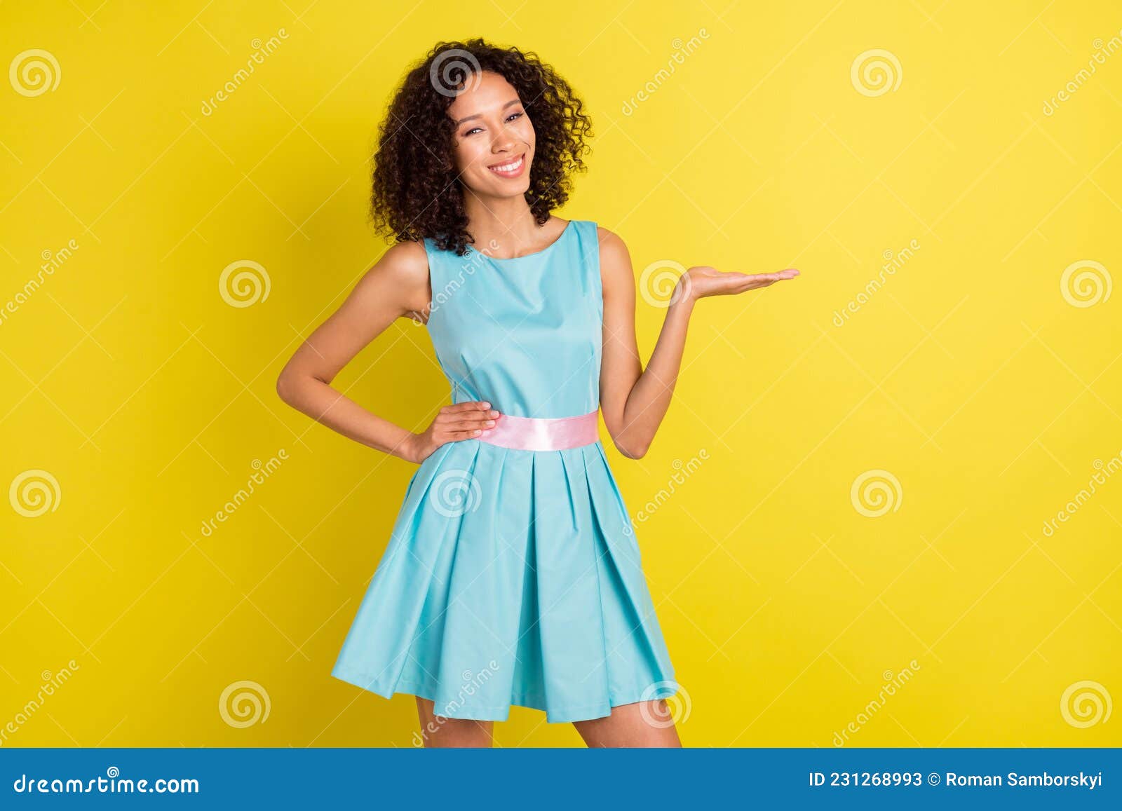 Photo Of Sweet Curly Hairdo Young Lady Show Empty Space Wear Blue Dress