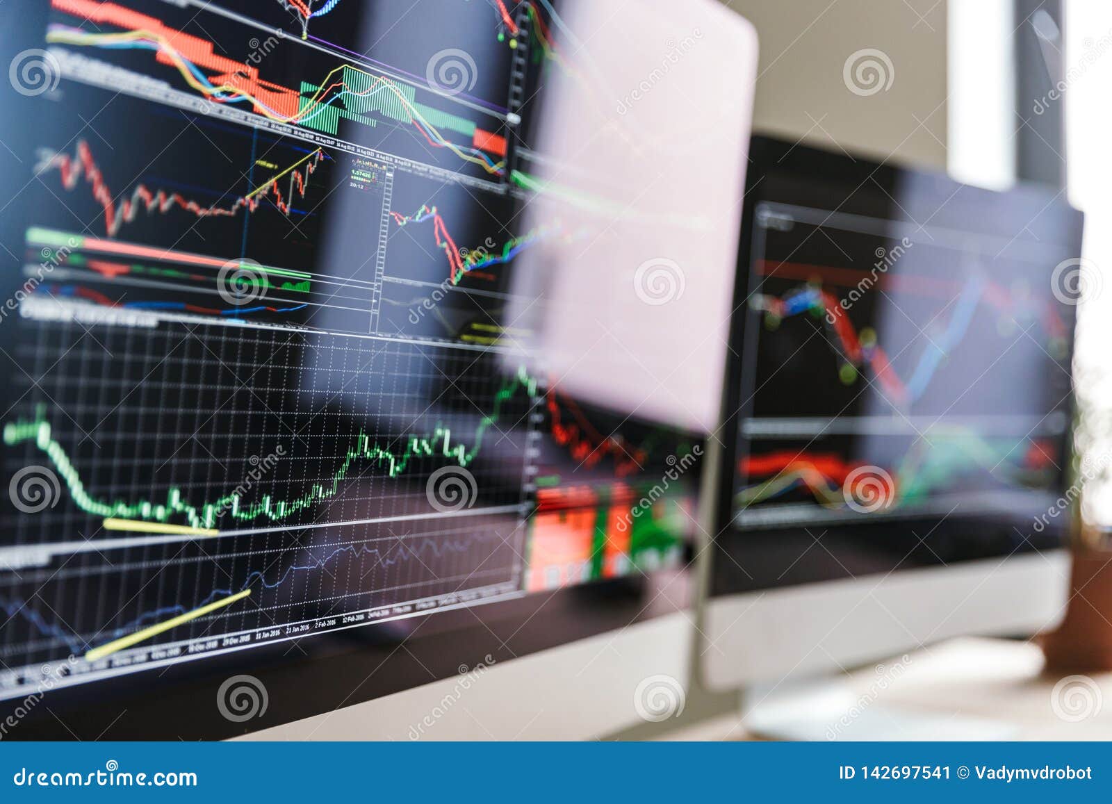 Photo of Two Computer Screens with Colorful Graphics and Charts in ...