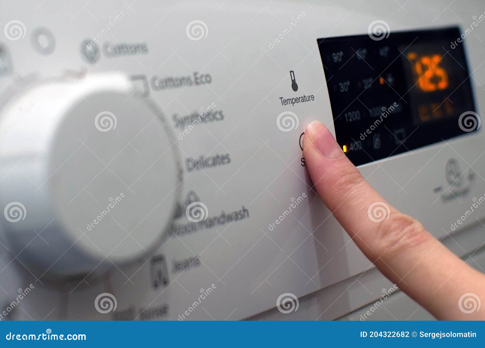 Photo of a Woman Setting Up the Washing Machine, Adjusting the Washing ...