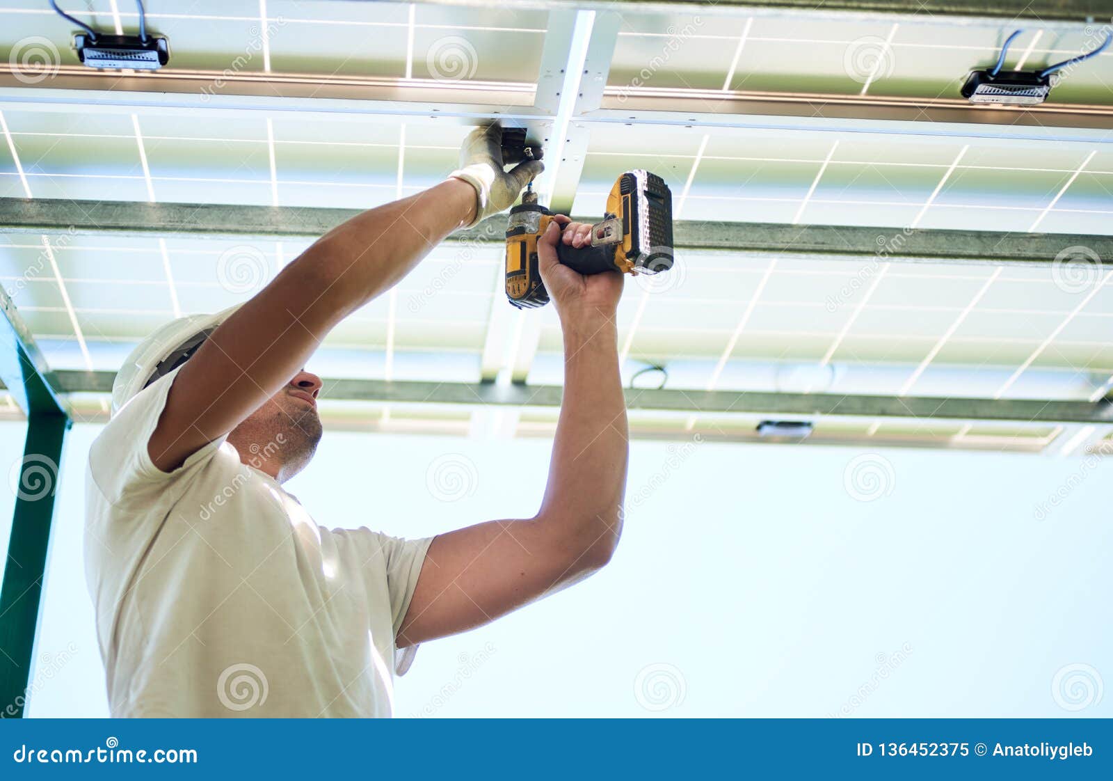 Photo of Worker Using Drill by Solar Panels Installing. Stock Image ...