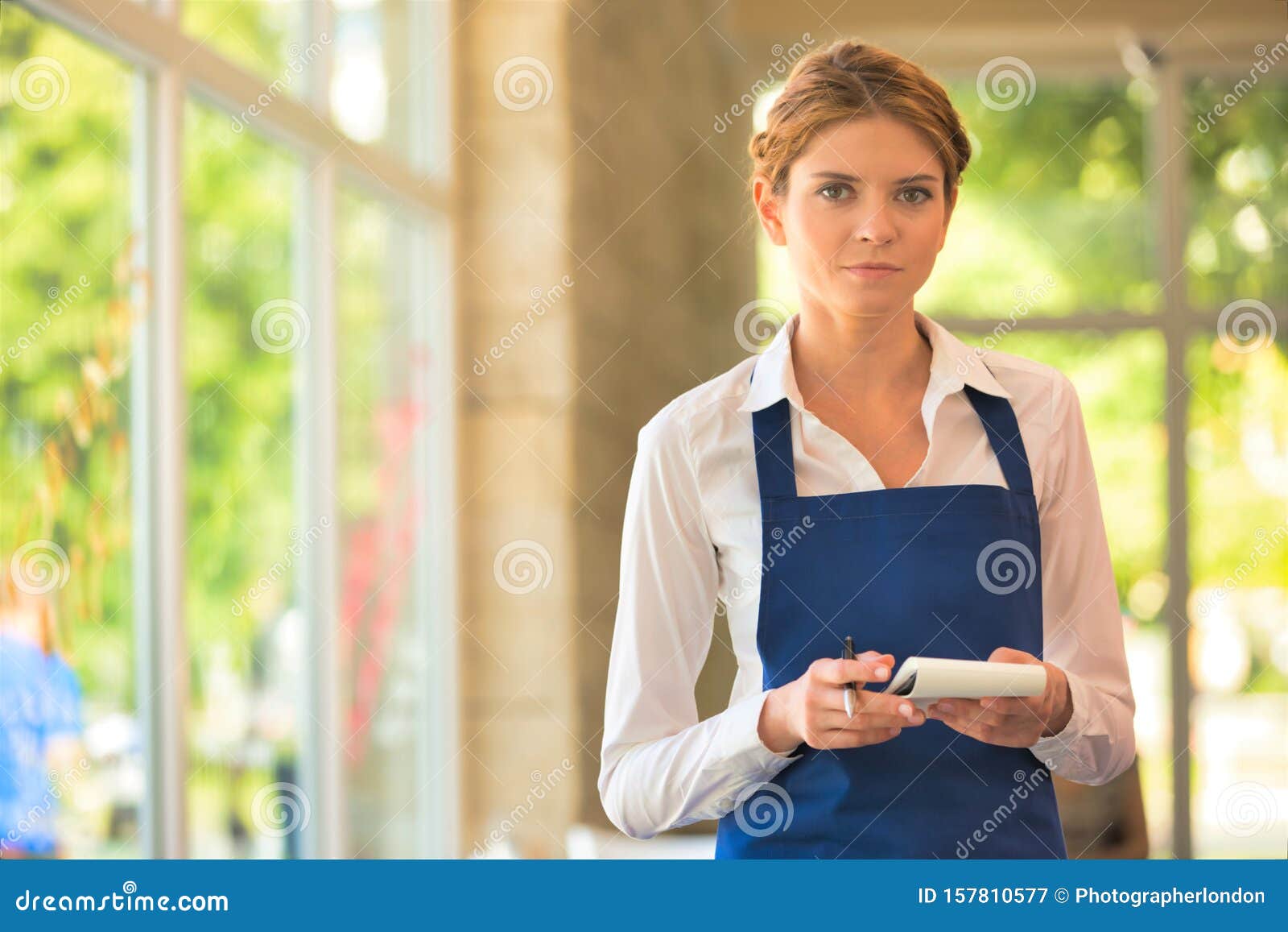 Young Confident Waitress Writing on Notepad at Restaurant Stock Image ...