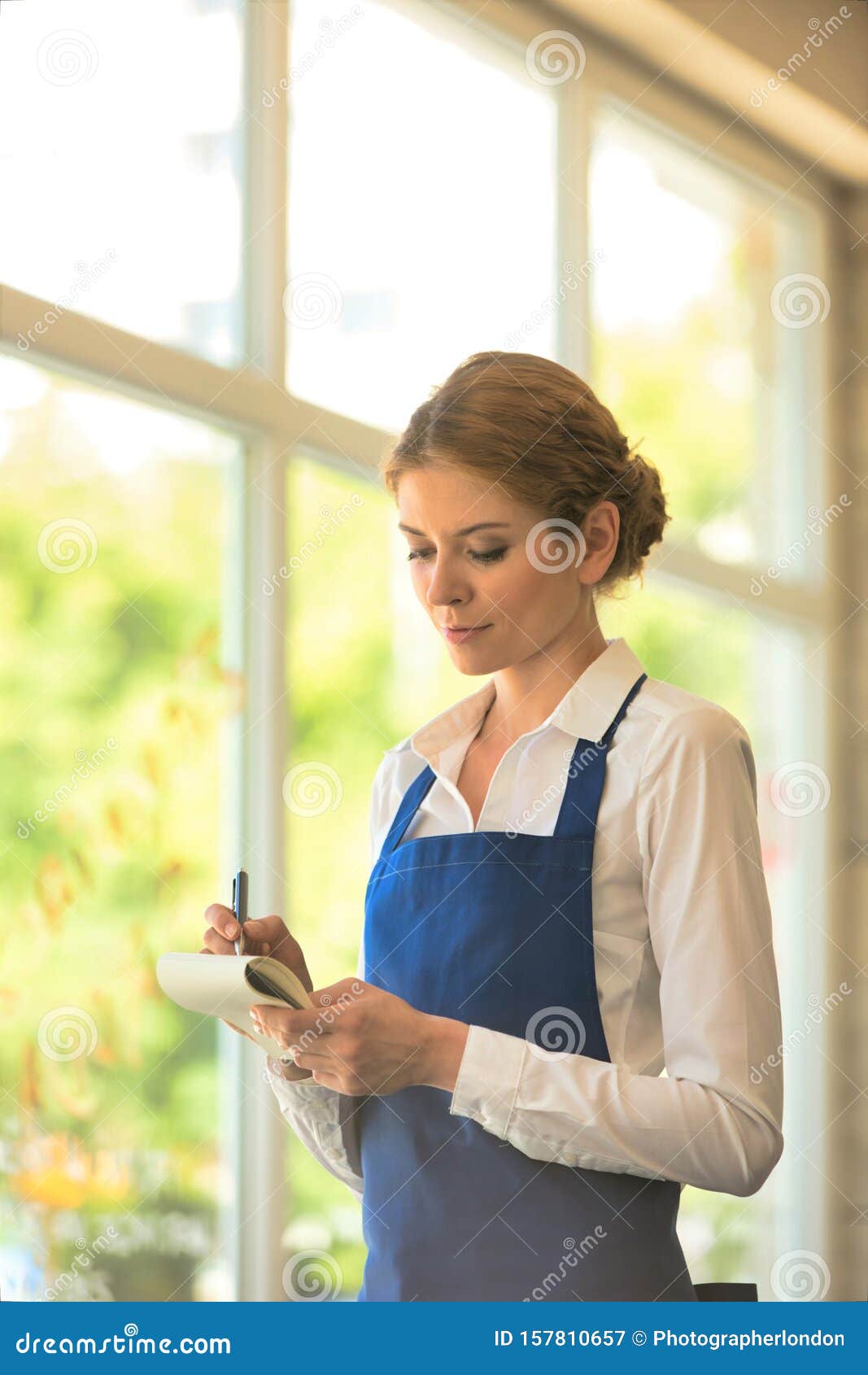 Young Confident Waitress Writing on Notepad at Restaurant Stock Image ...