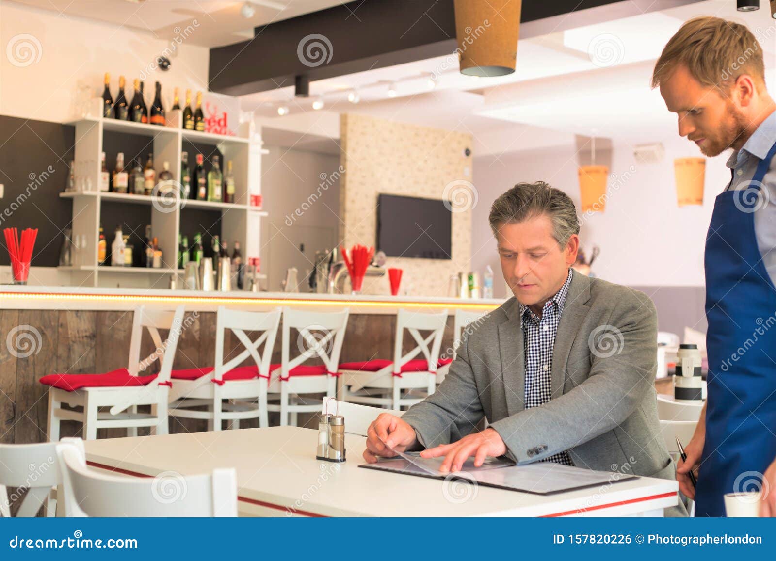Young Waiter Taking Orders from Customer at Restaurant Stock Photo ...