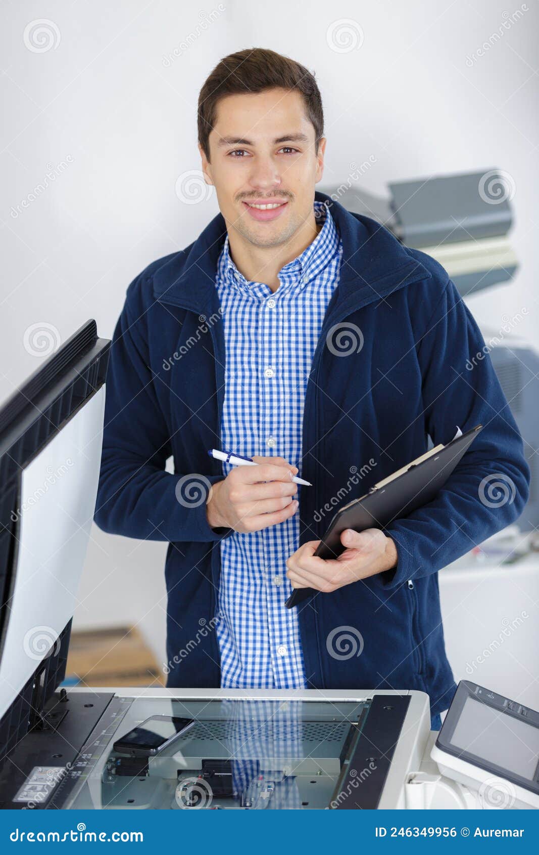 Photocopier Technician Holding Clipboard Next To Photocopier Stock ...