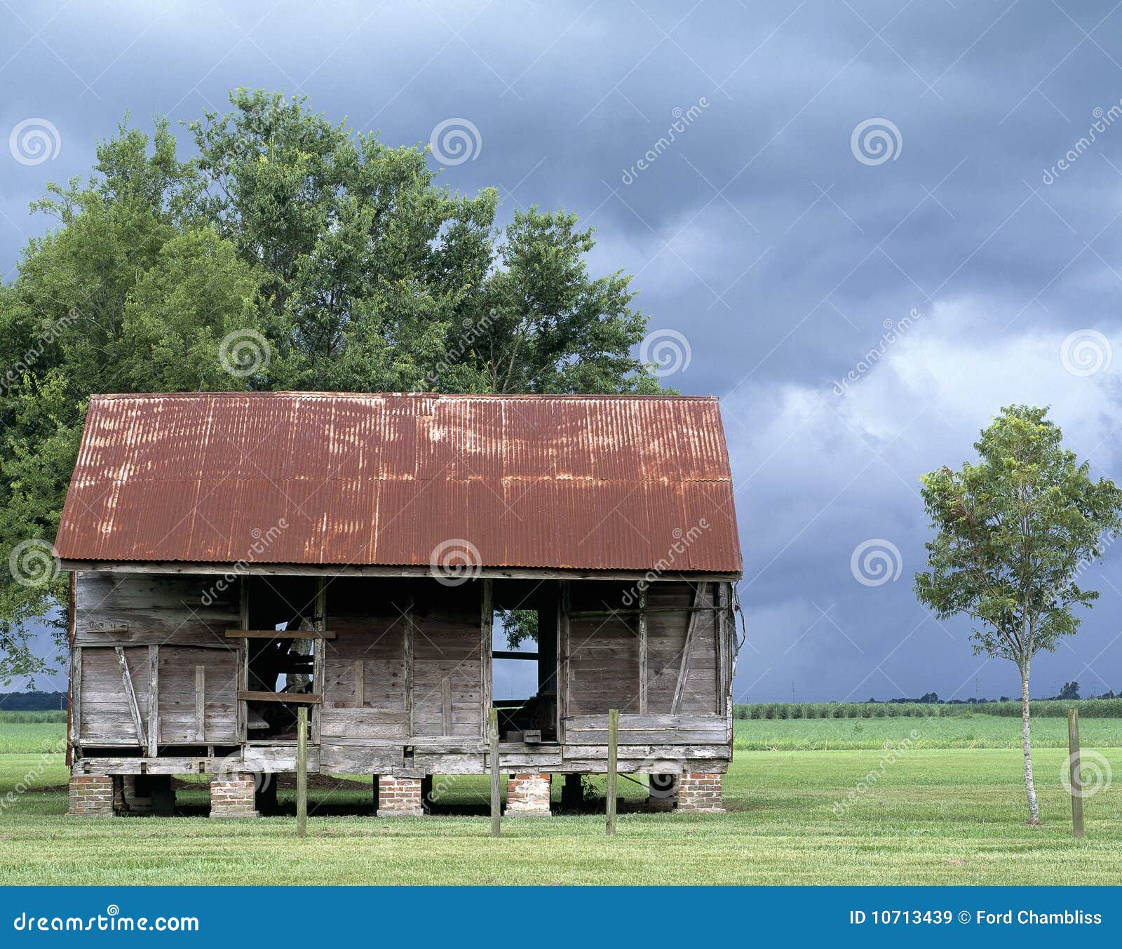 Photograph of an Abandoned House in a Field with a Stock Image - Image ...