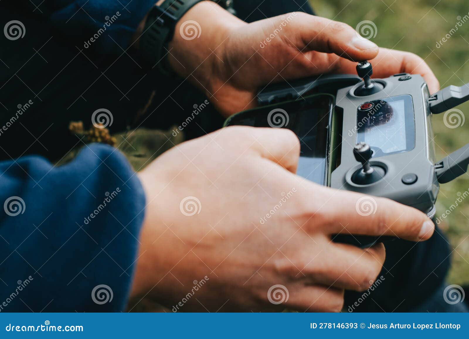Man S Hands Holding the Remote Control of a Drone (Drone Operator ...