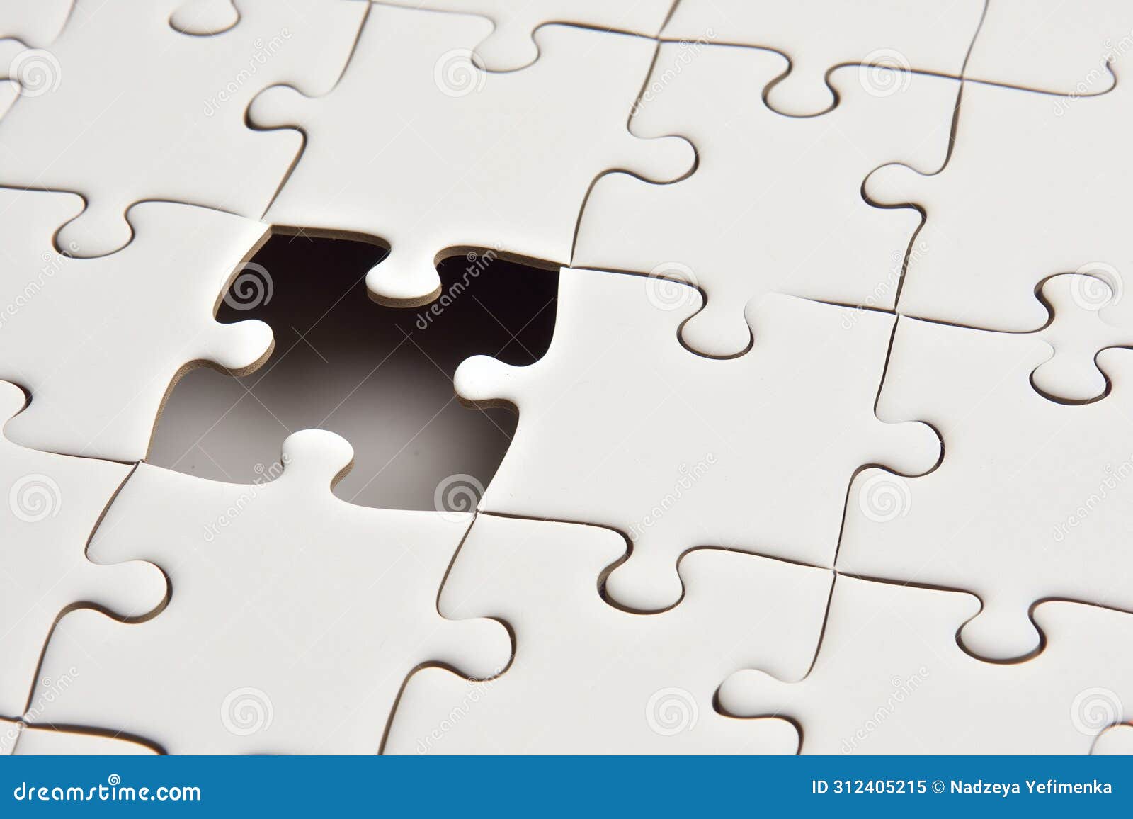 Incomplete White Jigsaw Puzzle with a Single Missing Piece Revealing a ...