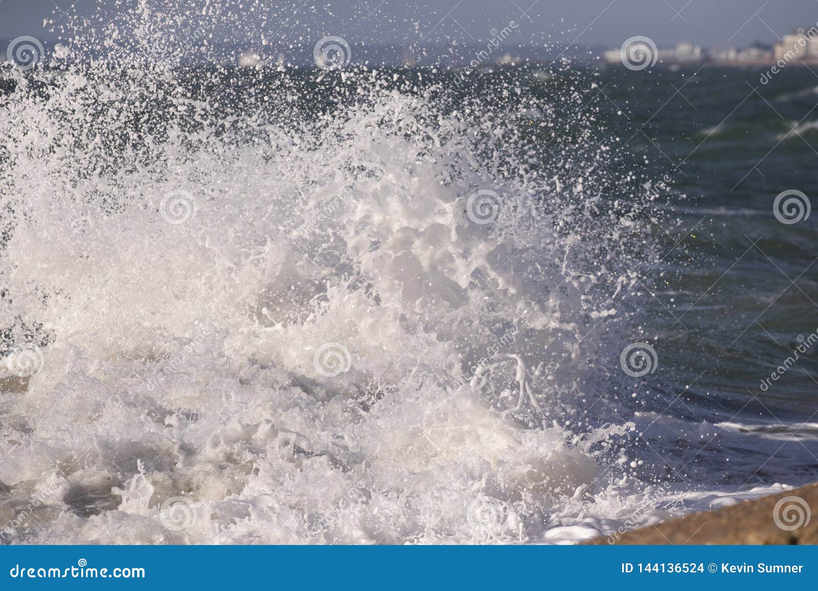 Waves crashing onto beach stock photo. Image of water - 144136524
