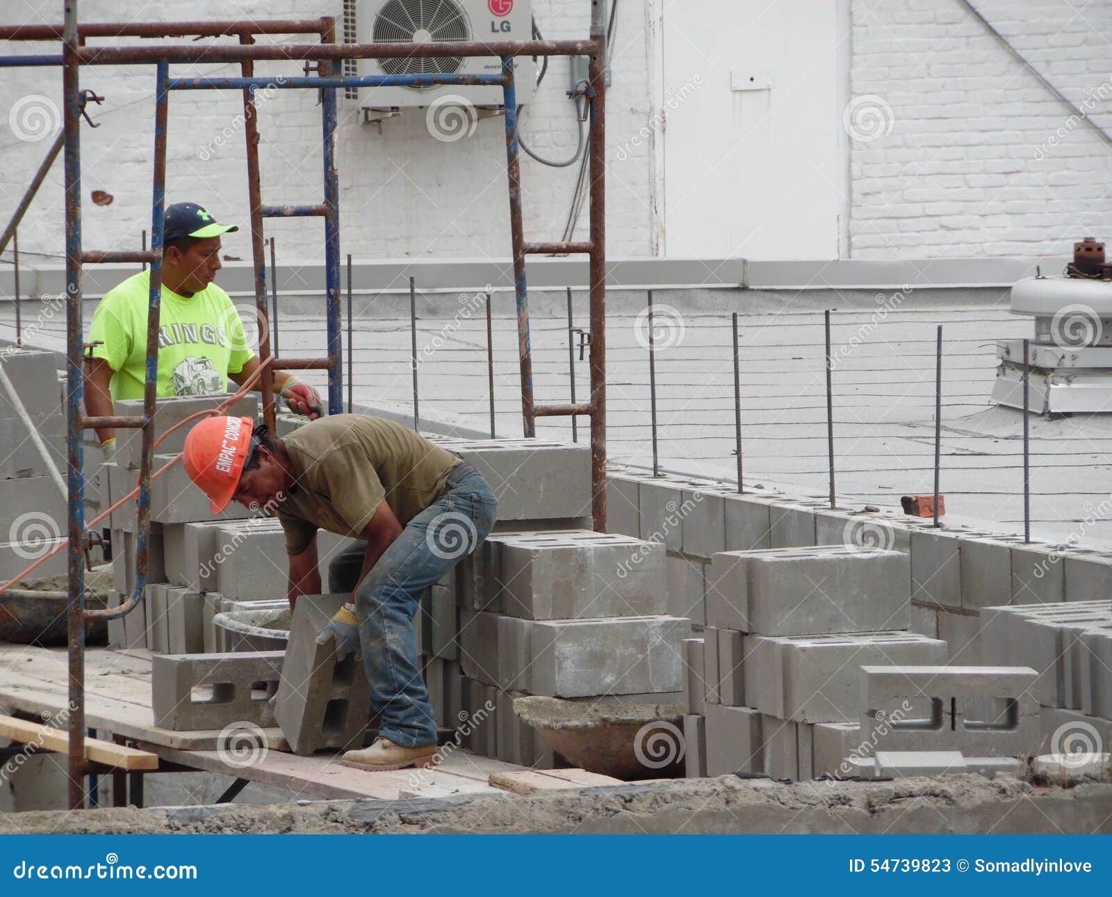 Photograph of Working Men Building Wall Editorial Stock Photo - Image ...