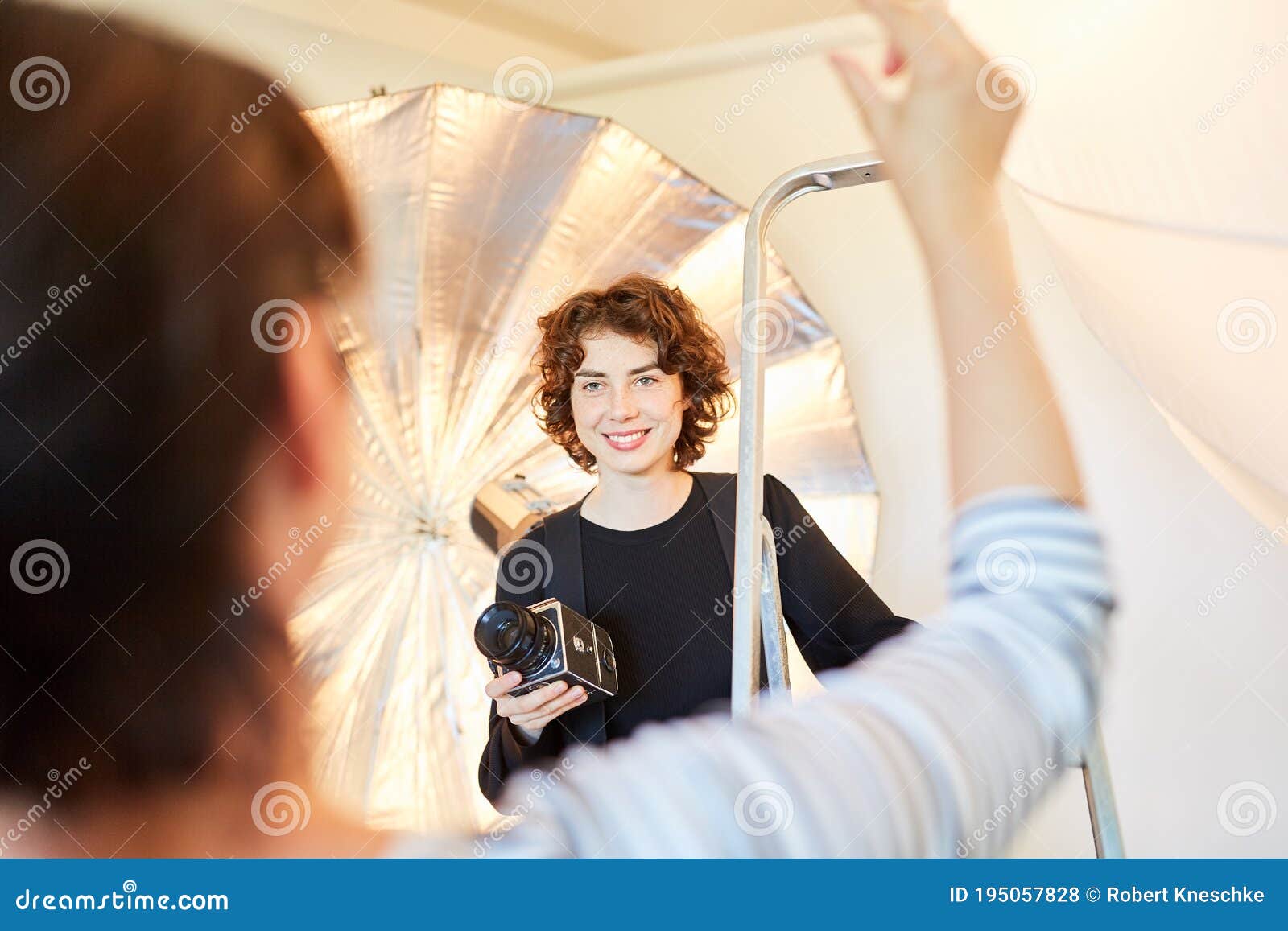 Photographer and Colleague Prepare for a Photo Shoot Stock Photo ...