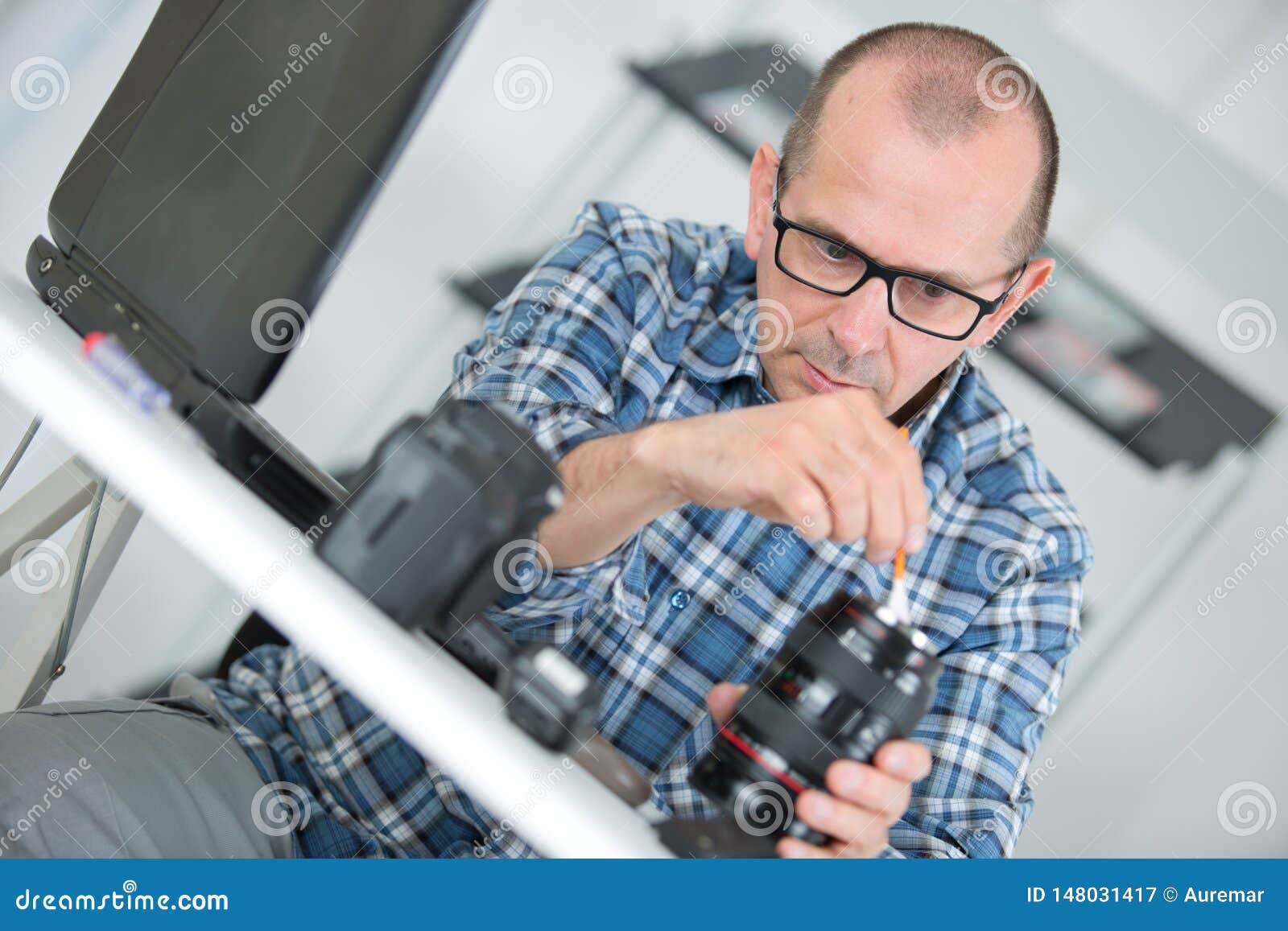Photographer Inspecting the Camera Stock Image - Image of office ...