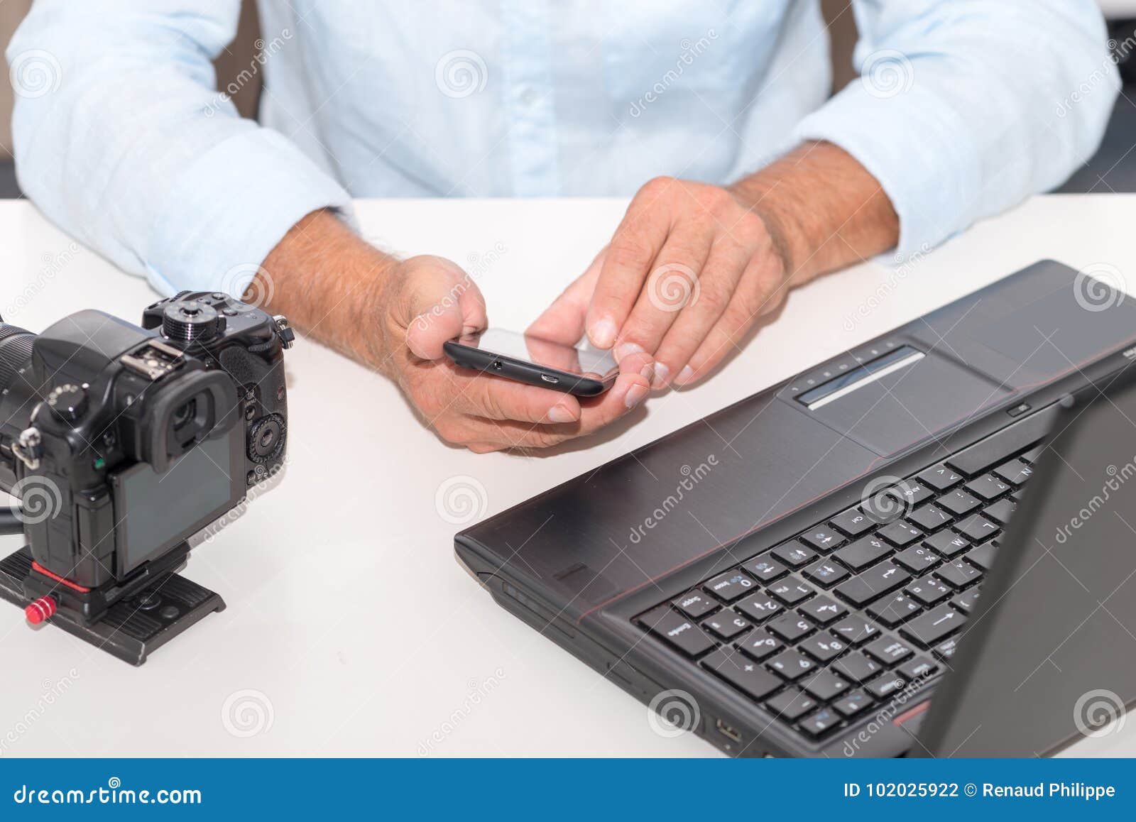 Photographer Man Using Smartphone and Laptop Computer Stock Photo ...