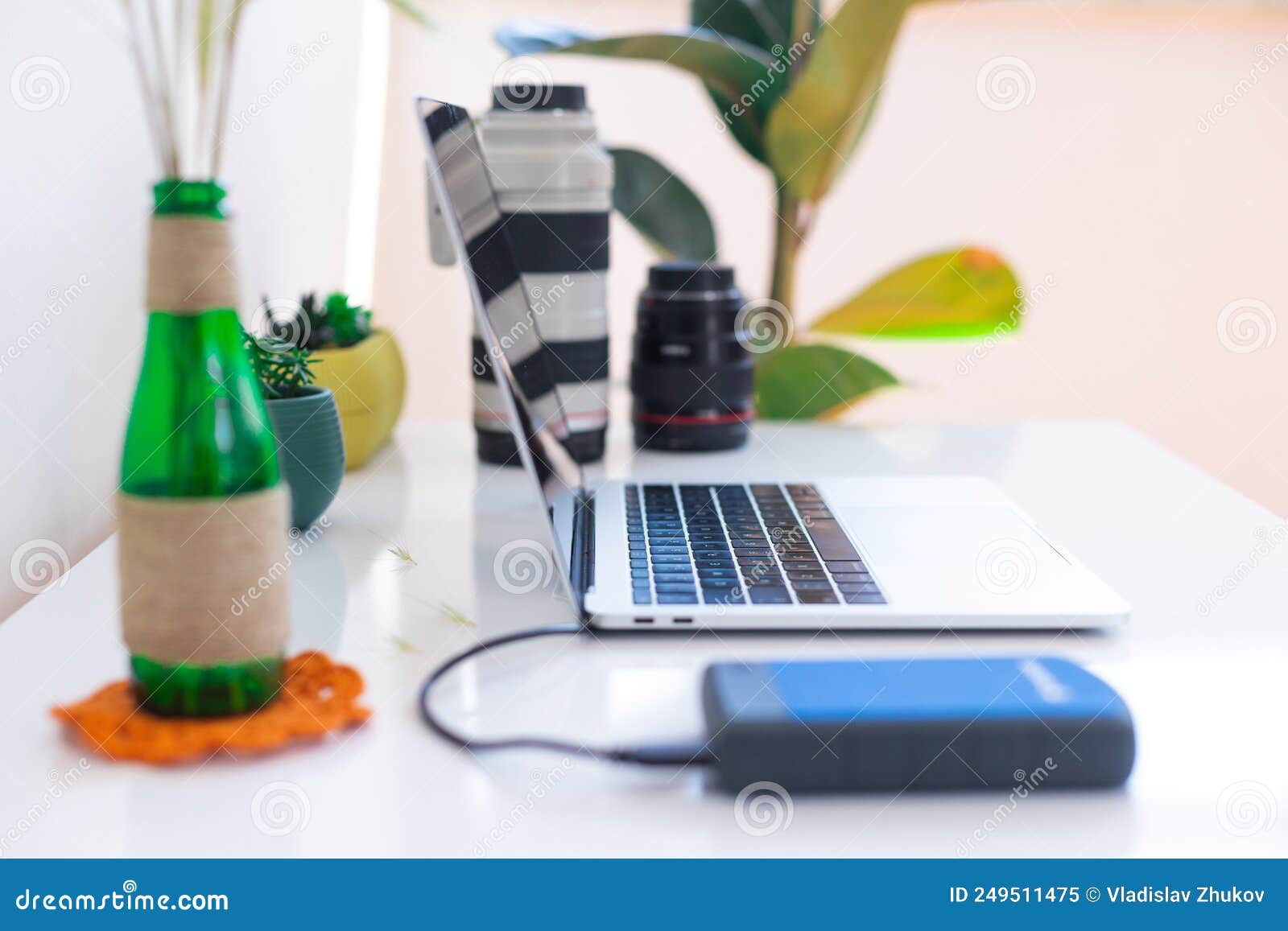 Photographer`s Workplace, Laptop and Camera Lenses on a White Table ...