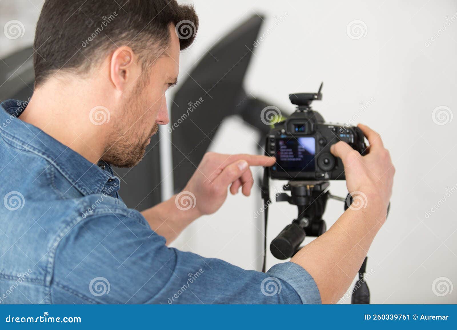 Photographer in Studio Adjusting Settings on Camera Stock Image - Image ...